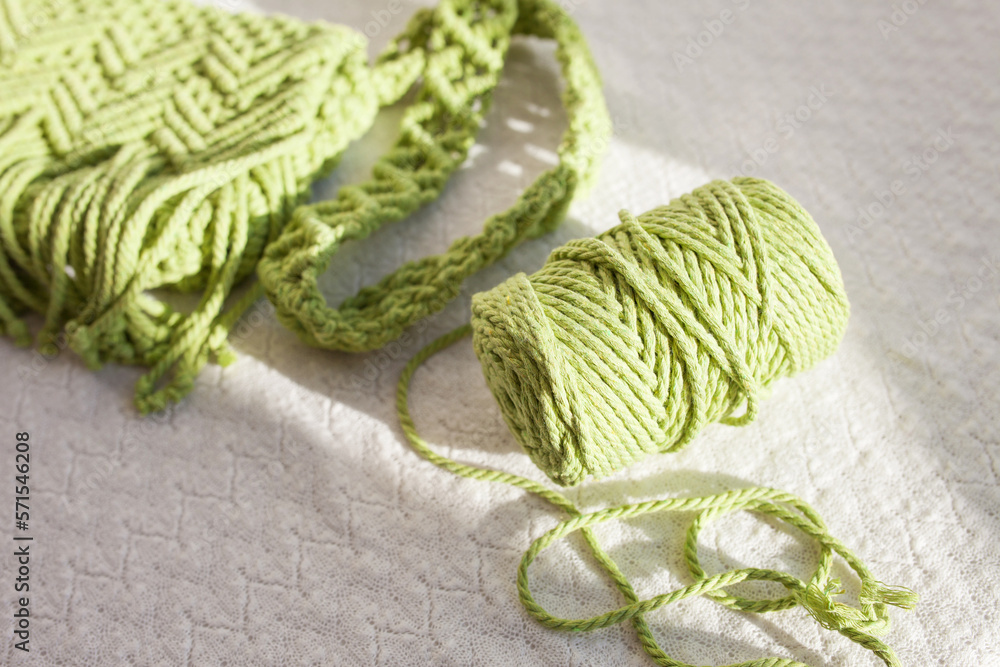 Handmade macrame braiding and cotton threads on textile white ...
