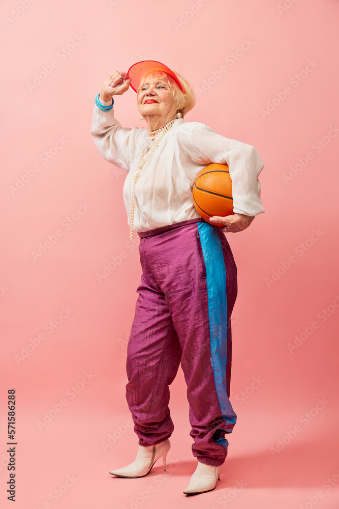 Sportive past. Beautiful old woman, grandmother in stylish clothes ...