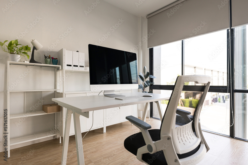 White table and chair with computer monitor and modern file cabinet in ...