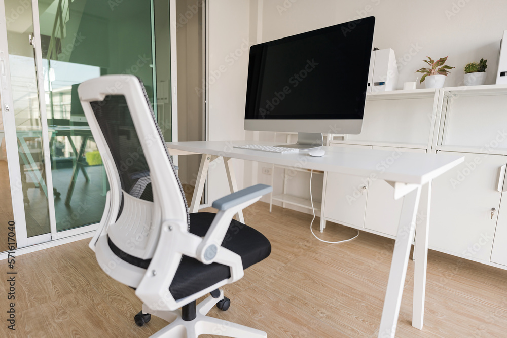White table and chair with computer monitor and modern file cabinet in ...