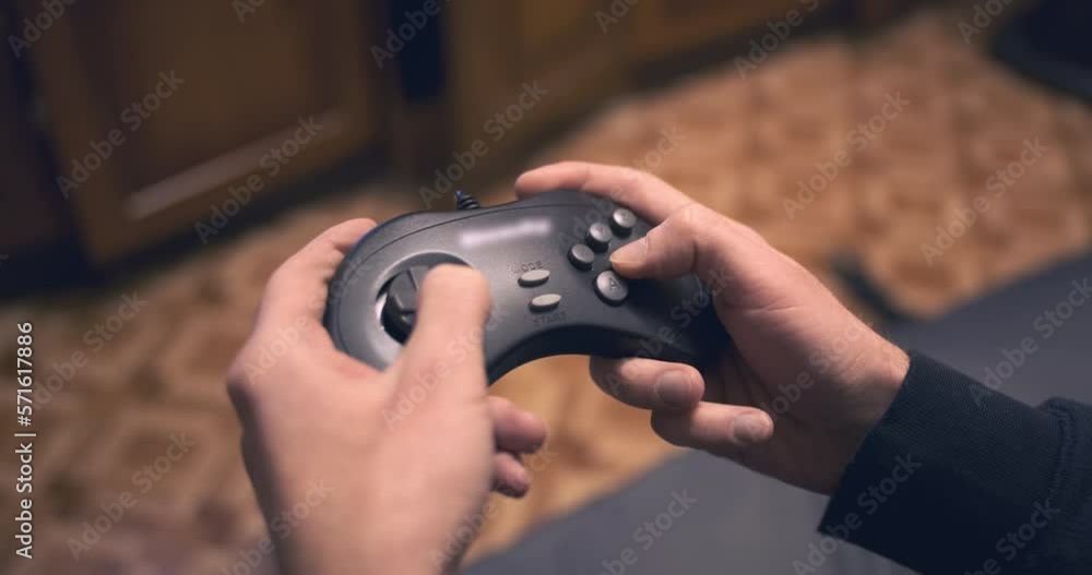 Fingers active, fast pressing game joystick buttons, close up. Man ...