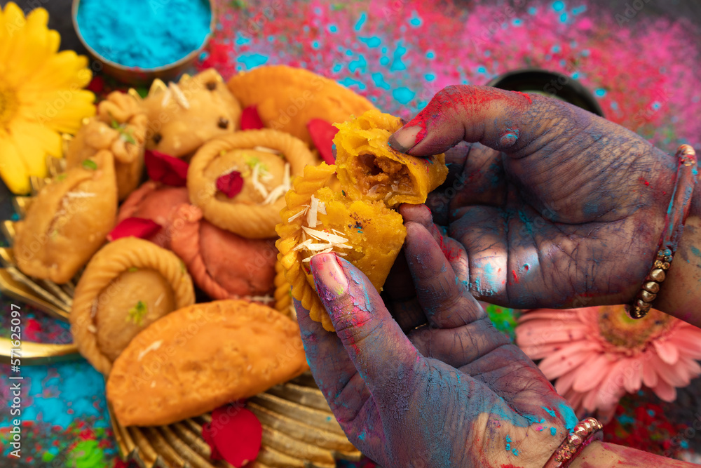 Hands Of A Girl Painted With Colorful Gulal Holding Delicious Gujiya ...
