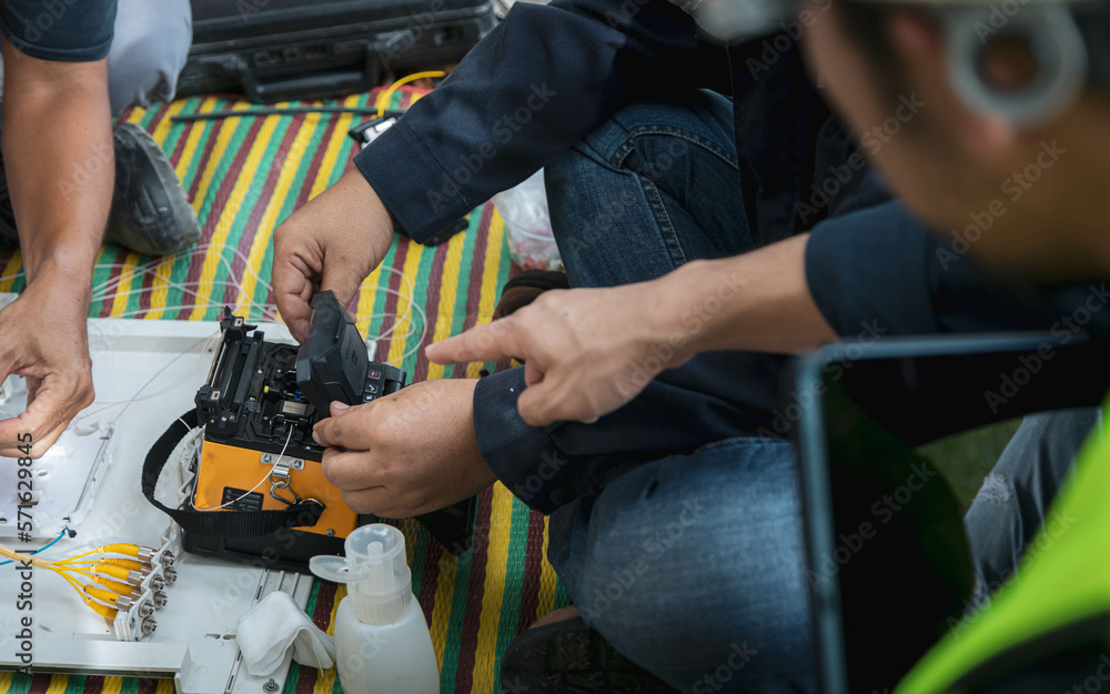 Engineer is inspecting connecting fiber optic and optical distribution ...