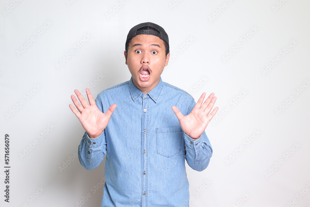 Oh my god! Portrait of scared Asian man in blue shirt with snapback ...