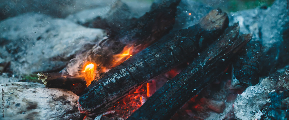 Vivid smoldered firewoods burned in fire close-up. Atmospheric warm ...