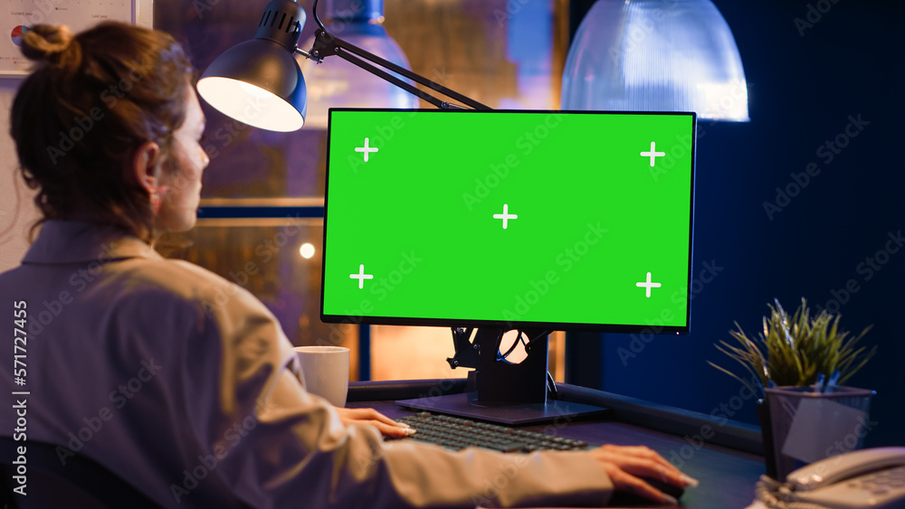 Business woman analyzing green screen display on pc, looking at ...