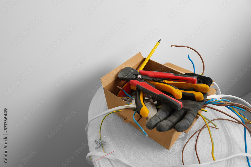 Different tools and cables in paper indoors. Installation of electrical ...