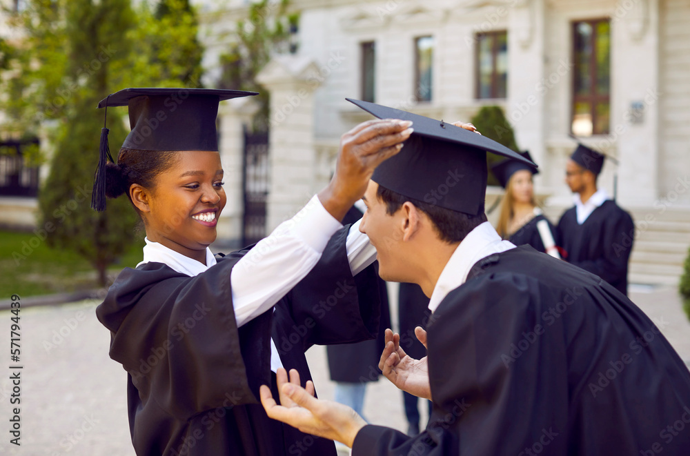Foto de Graduates preparing for graduation. Joyful female student ...