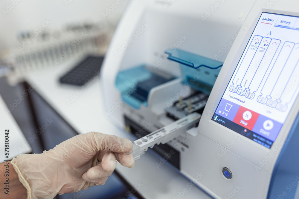 Female laboratory assistant making analysis with test tubes and ...