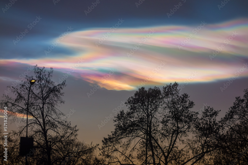Colorful sky at sunset, seen over the silhouette of some trees. The sky ...