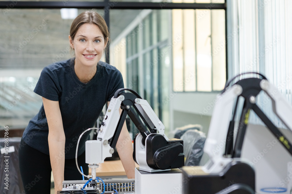 Female staff engineer with robot for education on table at class room ...