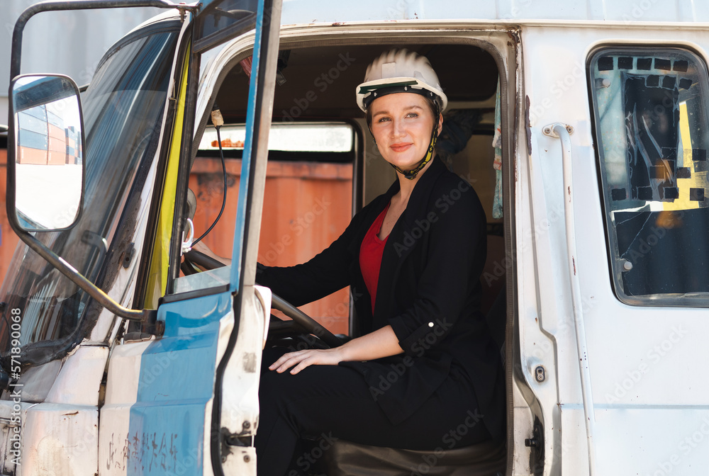 Engineer woman wears safety helmet sitting in a truck. Portrait of ...