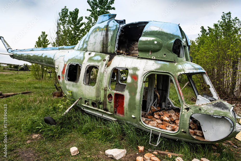 Destroyed military old helicopter at the airfield. Soviet Union army ...