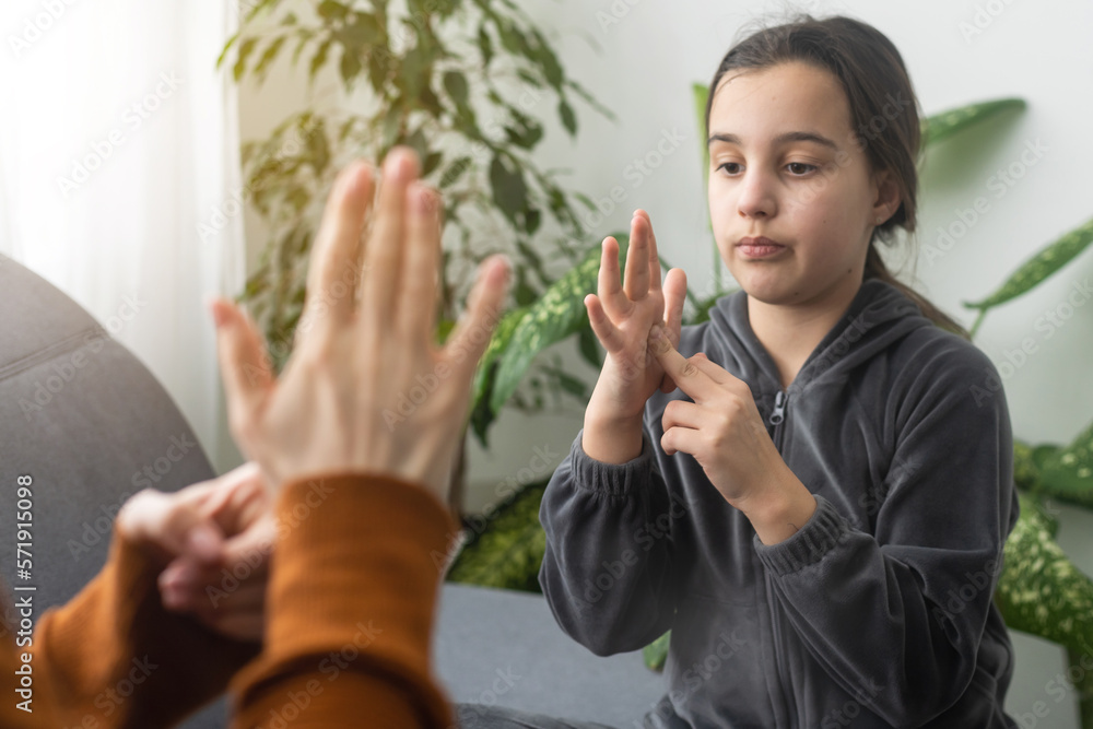 Small Caucasian teen girl child do articulation exercises with caring ...