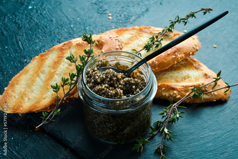Beluga black caviar and toast bread. Preparation of luxury snacks. On a ...