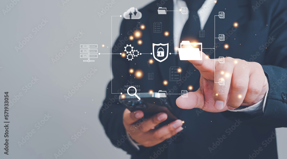 Document management system concept, Businessman pointing folder icon on virtual screen data ...