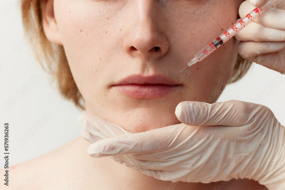 Young redhead man having cosmetological injections. Male model posing ...