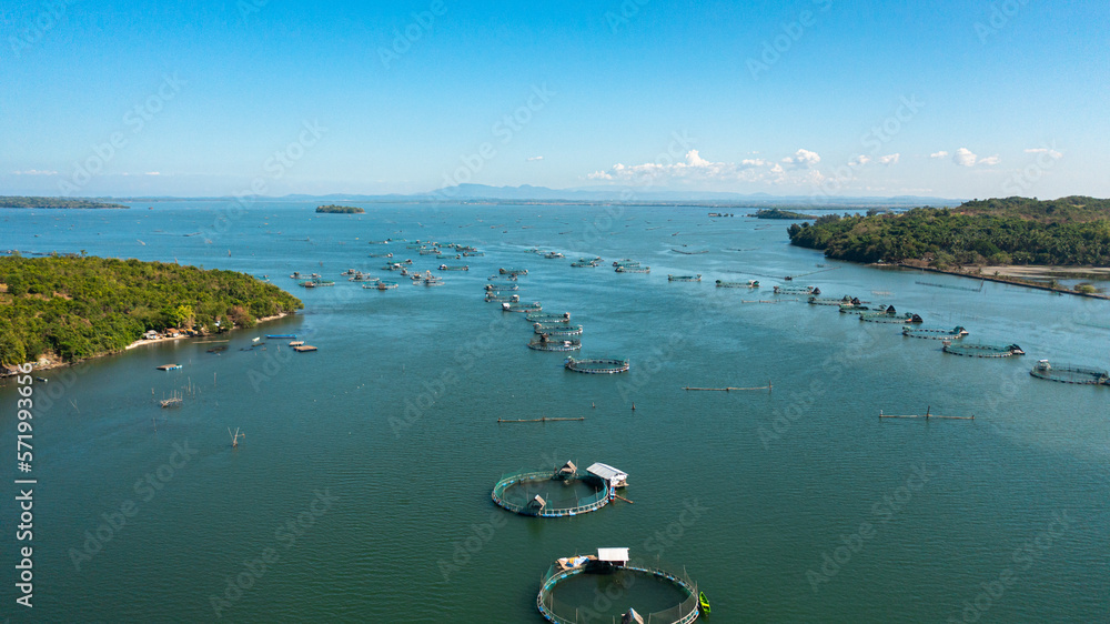 Fish farm with cages for fish and shrimp. Fish ponds for bangus ...