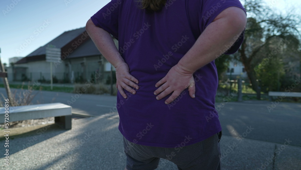 One overweight man suffering from back pain outside. A fat guy having ...