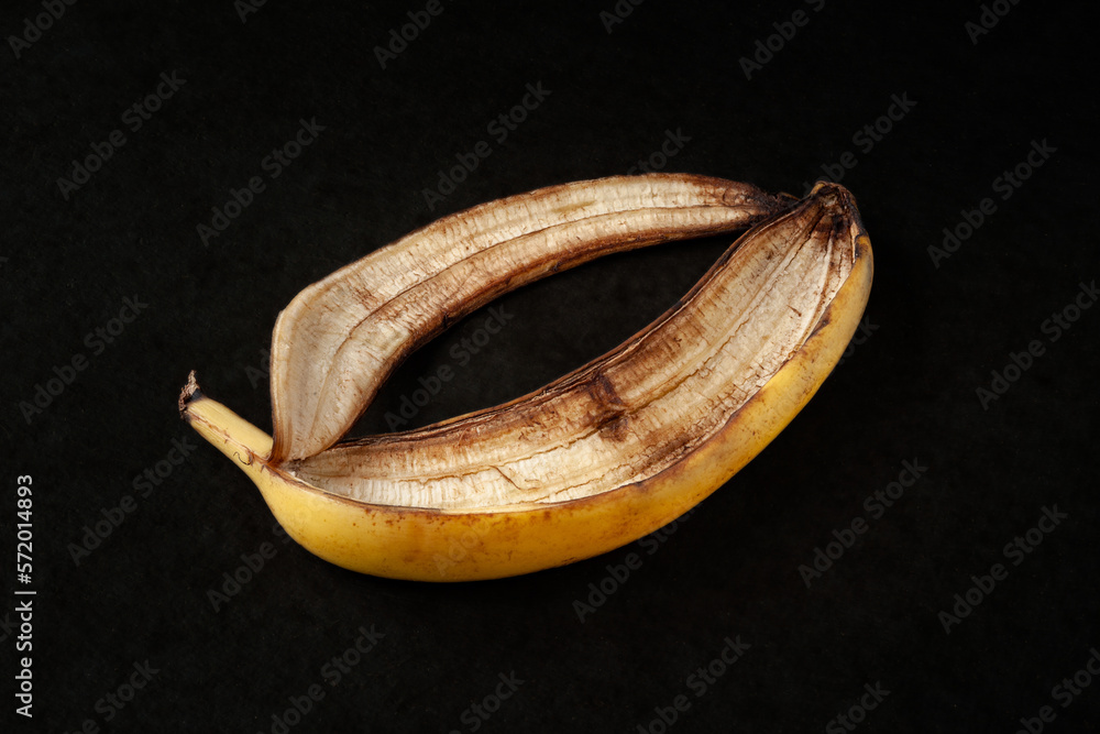 Banana peel on a black background. One over-ripe banana close-up Stock ...