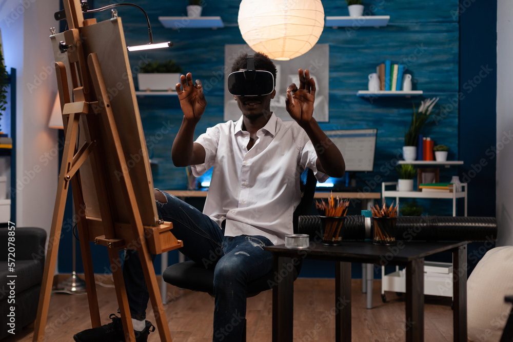 African american professional artist using virtual reality viewer to ...