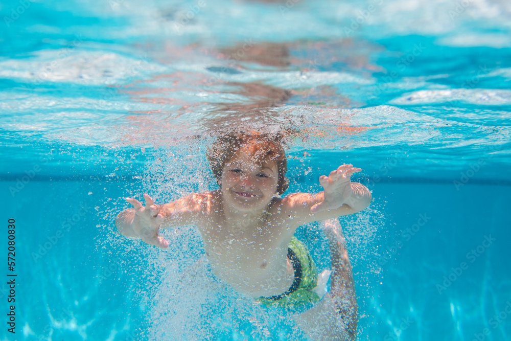 Boy Swimming Underwater In Ocean