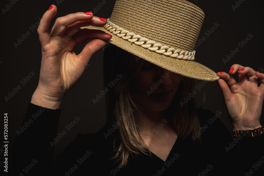 Close-up portrait of a young and beautiful girl making adjustments ...
