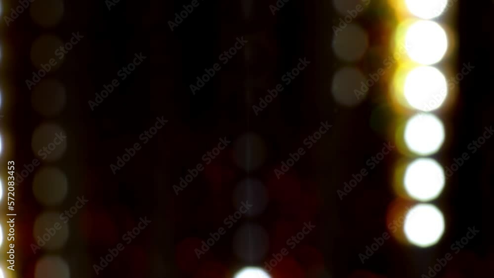 Glowing dotted bokeh lines running down across a black background. 4K ...