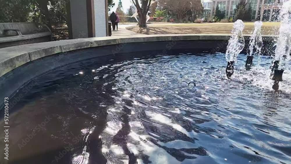 Slow motion footage of water shooting up out of a water fountain with ...