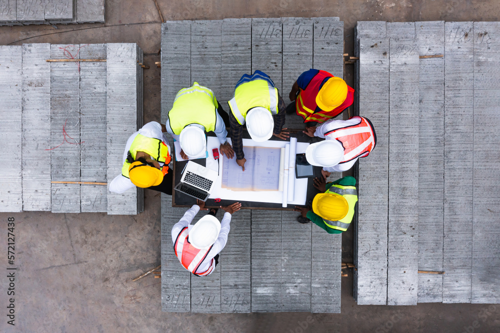 Aerial top view of architect and engineer discussing building plan at ...