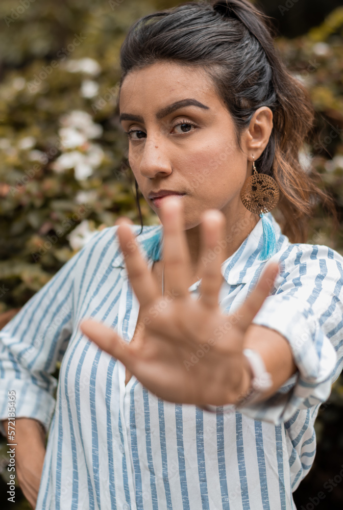 Woman showing stop gesture with her hand. Young female protesting ...