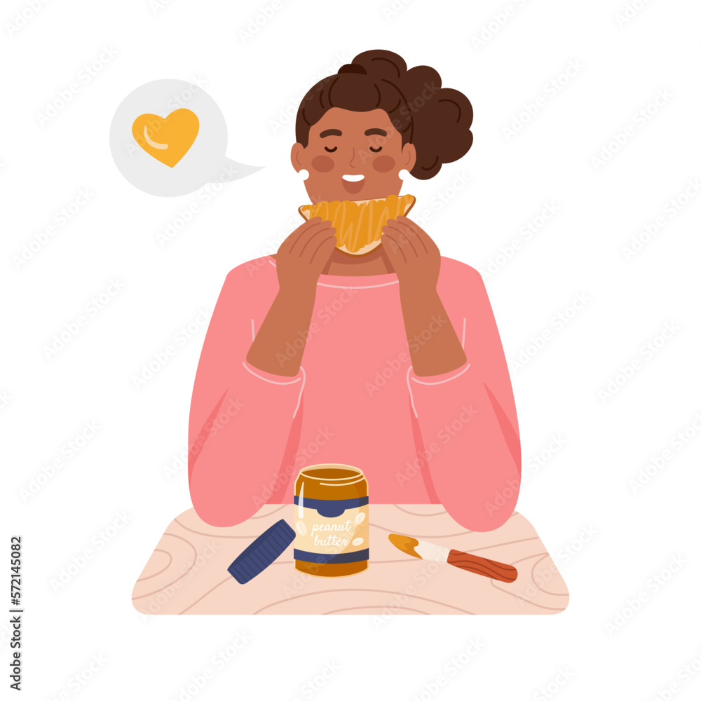 Happy woman eating peanut butter toast. Female sitting at table ...