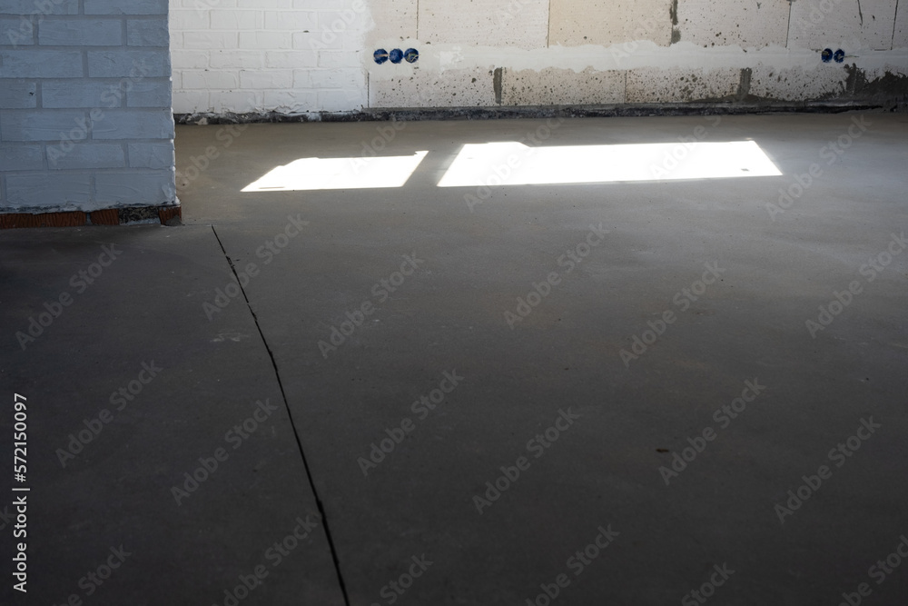 The leveled rough floor in a house under construction with a semi-dry ...
