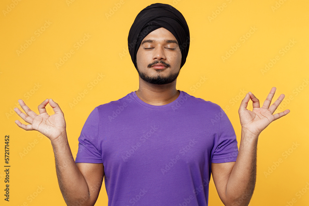 Devotee Sikh Indian man tie his traditional turban dastar wear purple t ...