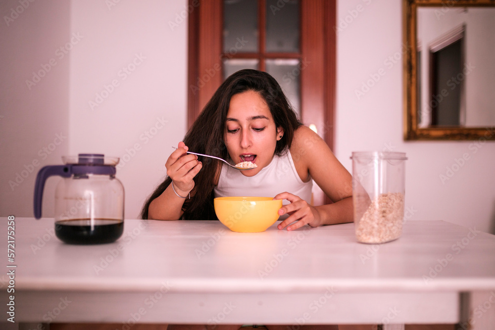 Teen girl eating milk with cereal Stock Photo | Adobe Stock