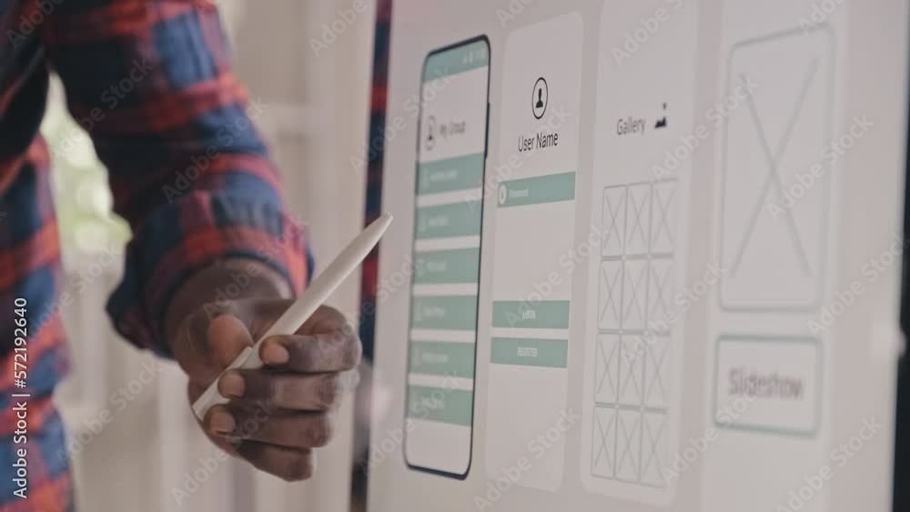 Close up impersonal shot of hand of male UX designer pointing at mobile ...