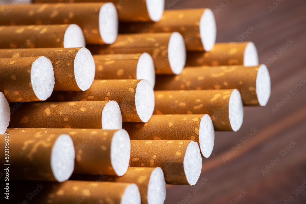 image of several commercially made cigarettes. pile cigarette on wooden ...