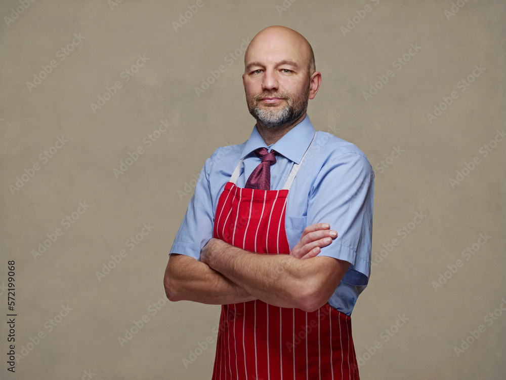 Portrait of a stylish male butcher wearing blue short sleeve shirt and ...