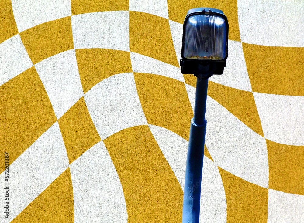 halogen street light and lamp post in front of abstract vasarely style ...