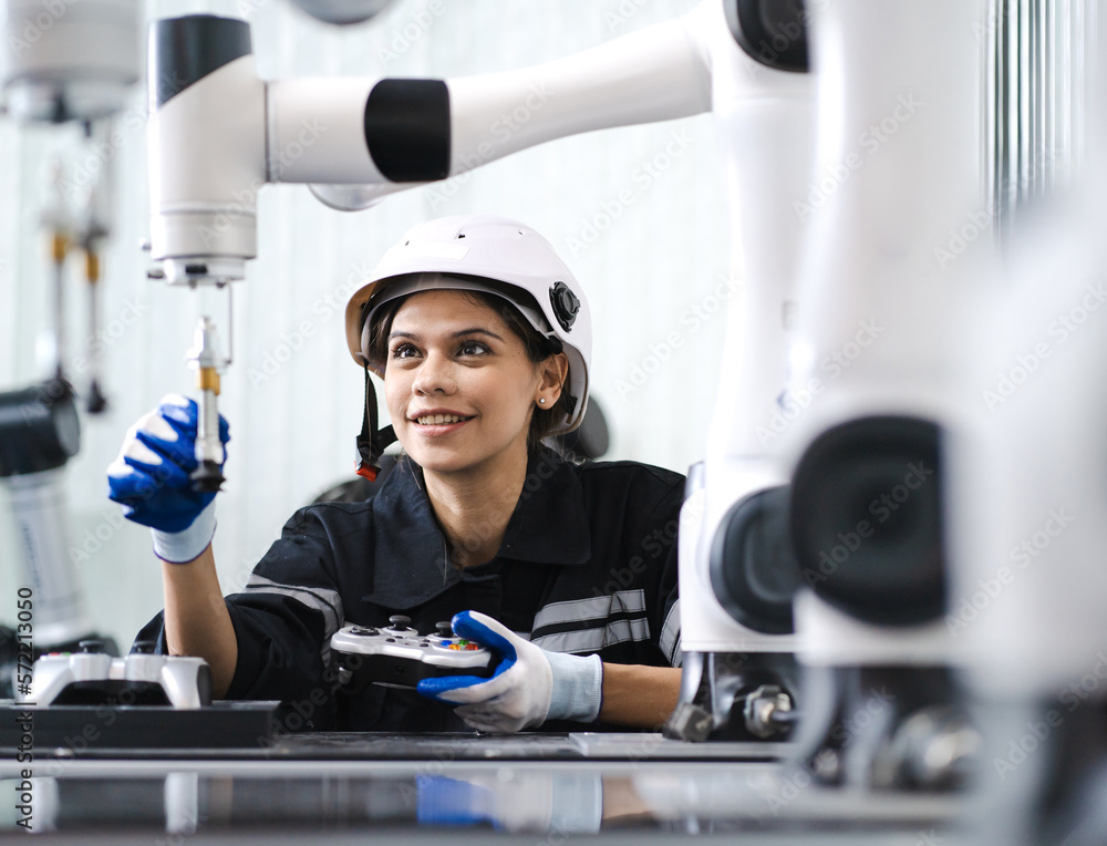 Computer science development engineer working on robot arm connection ...