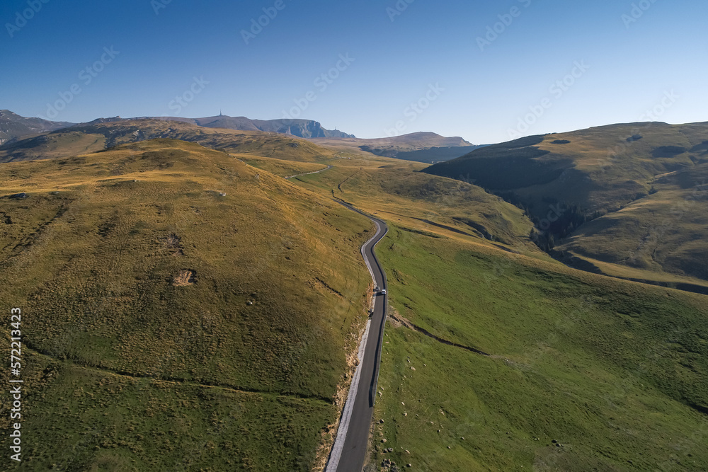 Aerial view of Bucegi Mountains and Transbucegi waving road on top of ...