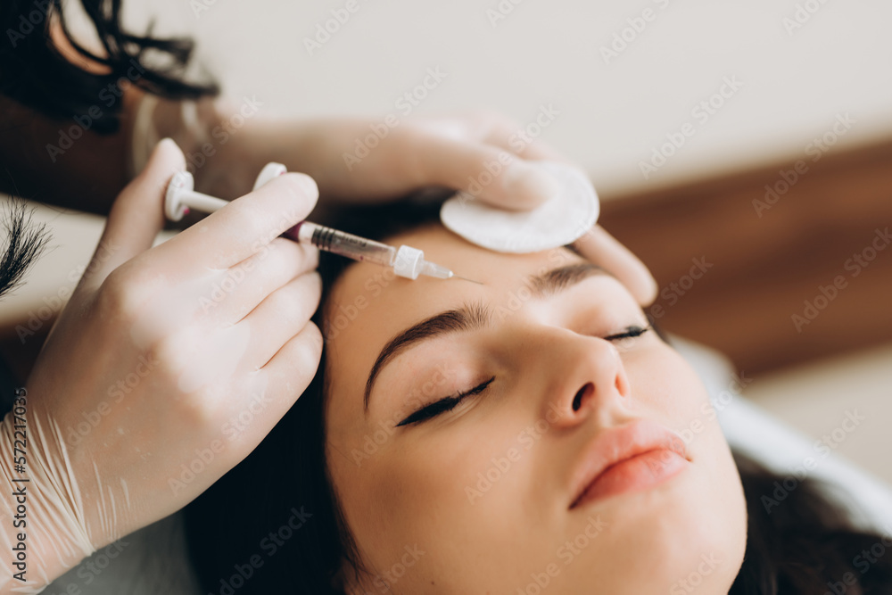Attractive woman scared of injection. Girl looking with fear at a ...