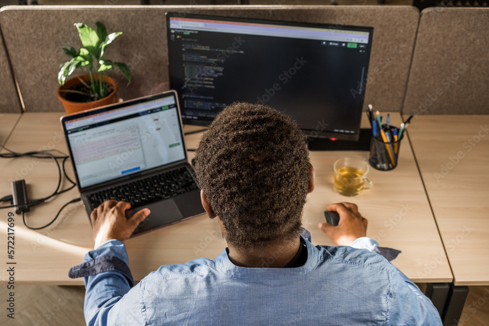 Foto de Black Man Writing Lines of Code On Desktop PC With Two Monitors ...