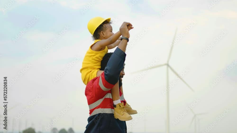 Black african father engineer holds his daughter in his arms at the ...