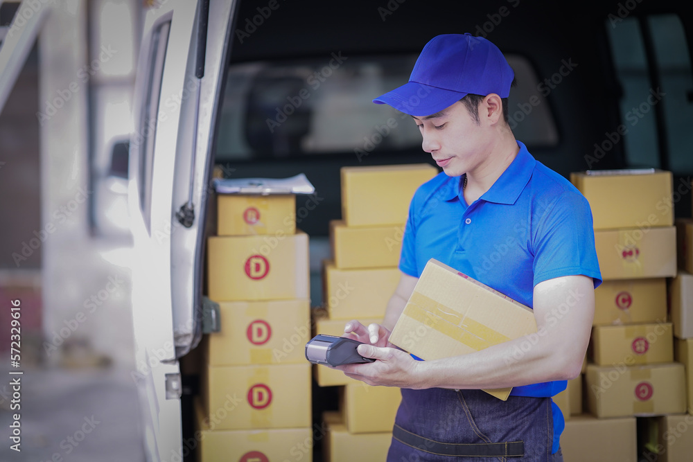 Deliver service. Man With Box in Car Outdoors Delivery Man in uniform ...
