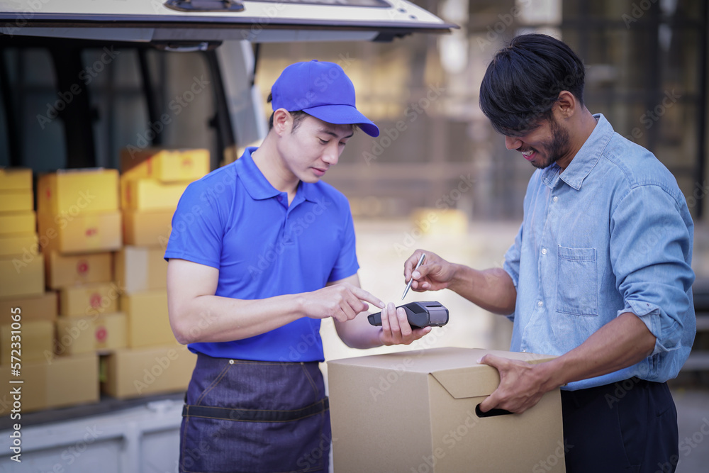 Deliver service. Man With Box in Car Outdoors Delivery Man in uniform ...