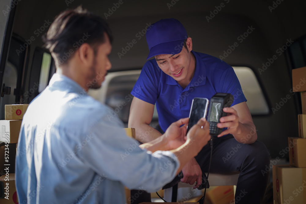 Deliver service. Man With Box in Car Outdoors Delivery Man in uniform ...