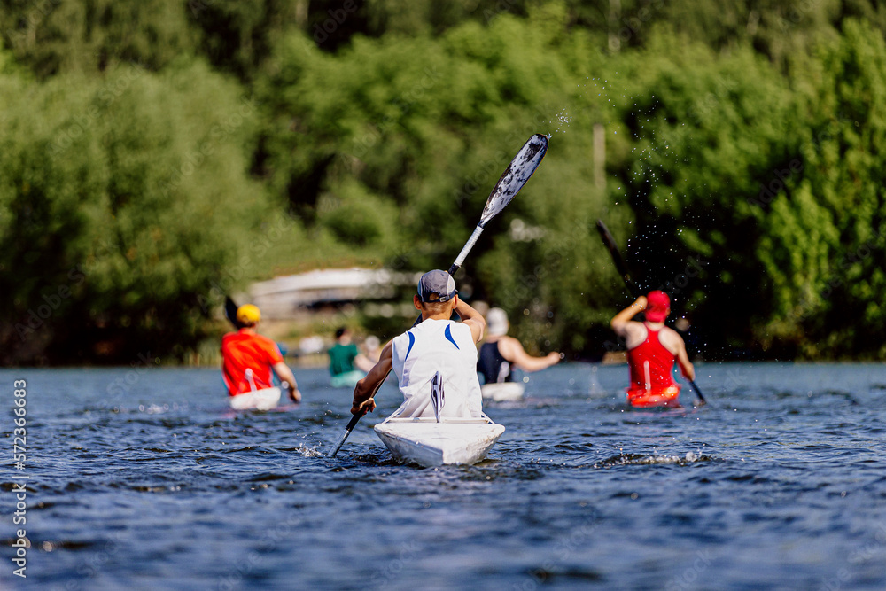 back group young athletes rowers kayaking on lake Stock Photo | Adobe Stock