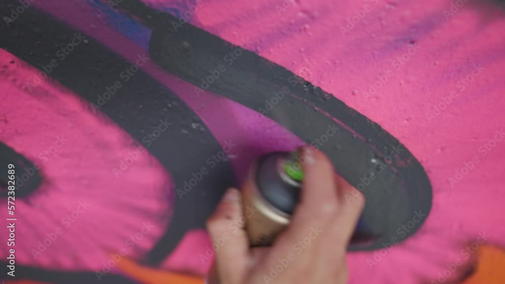 Spray Paint Wall Graffiti Art. person spraying painting on a wall in ...