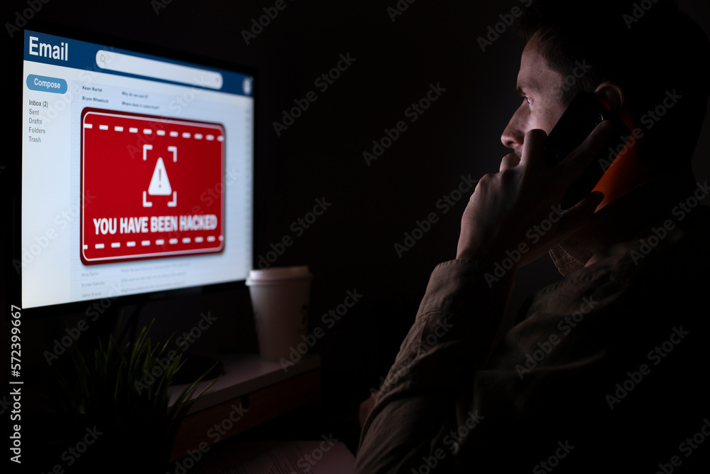 In the middle of the night, a young businessman checks his email when ...